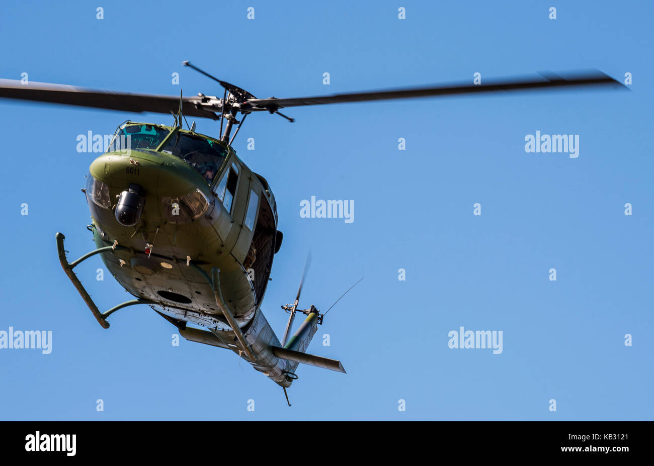 A UH-1N Huey from the 37th Helicopter Squadron soars overhead as it ...