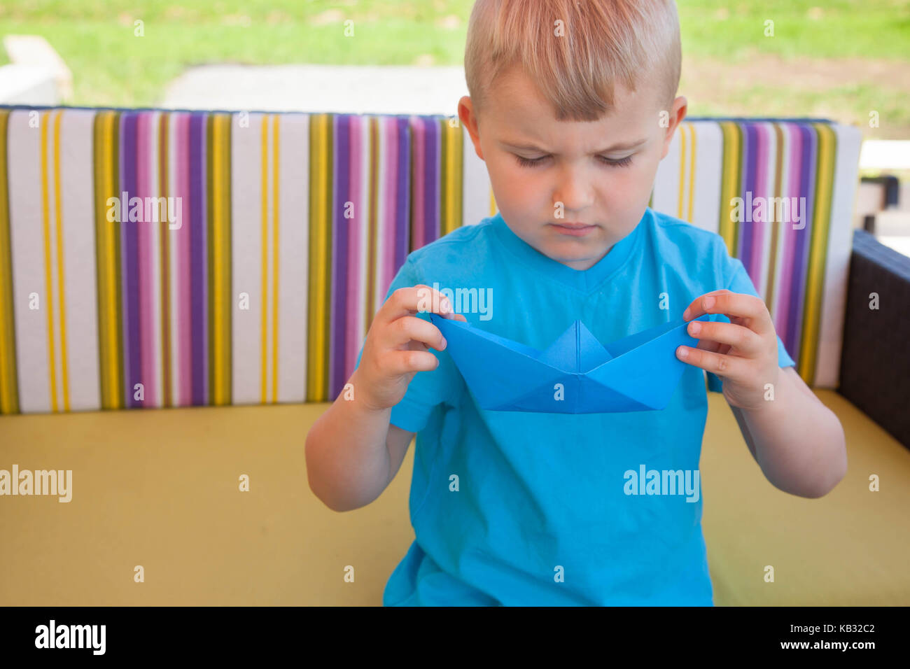 Child doing origami hi-res stock photography and images - Alamy