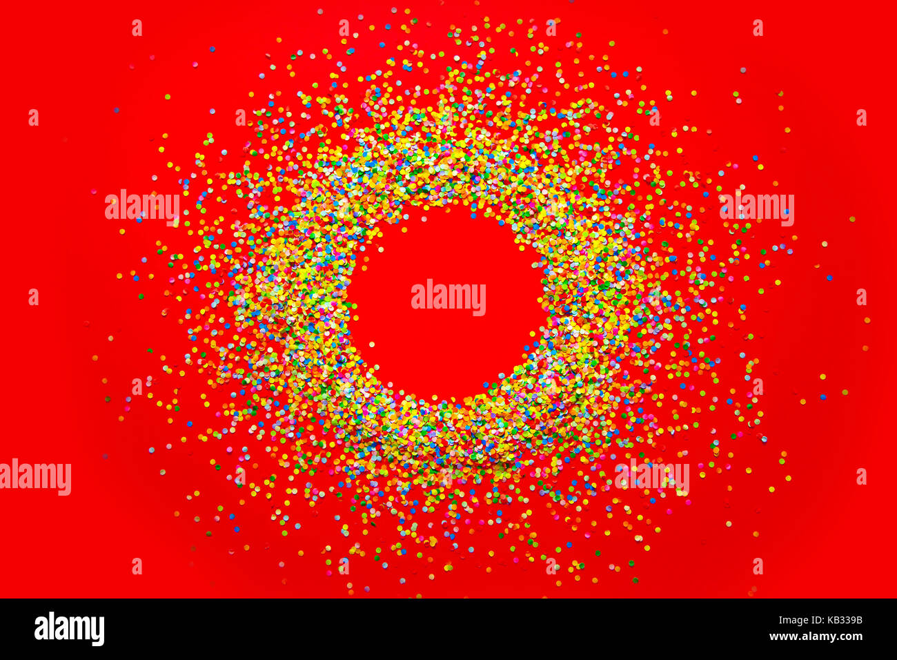 Frame made of colored confetti. Red background Stock Photo - Alamy