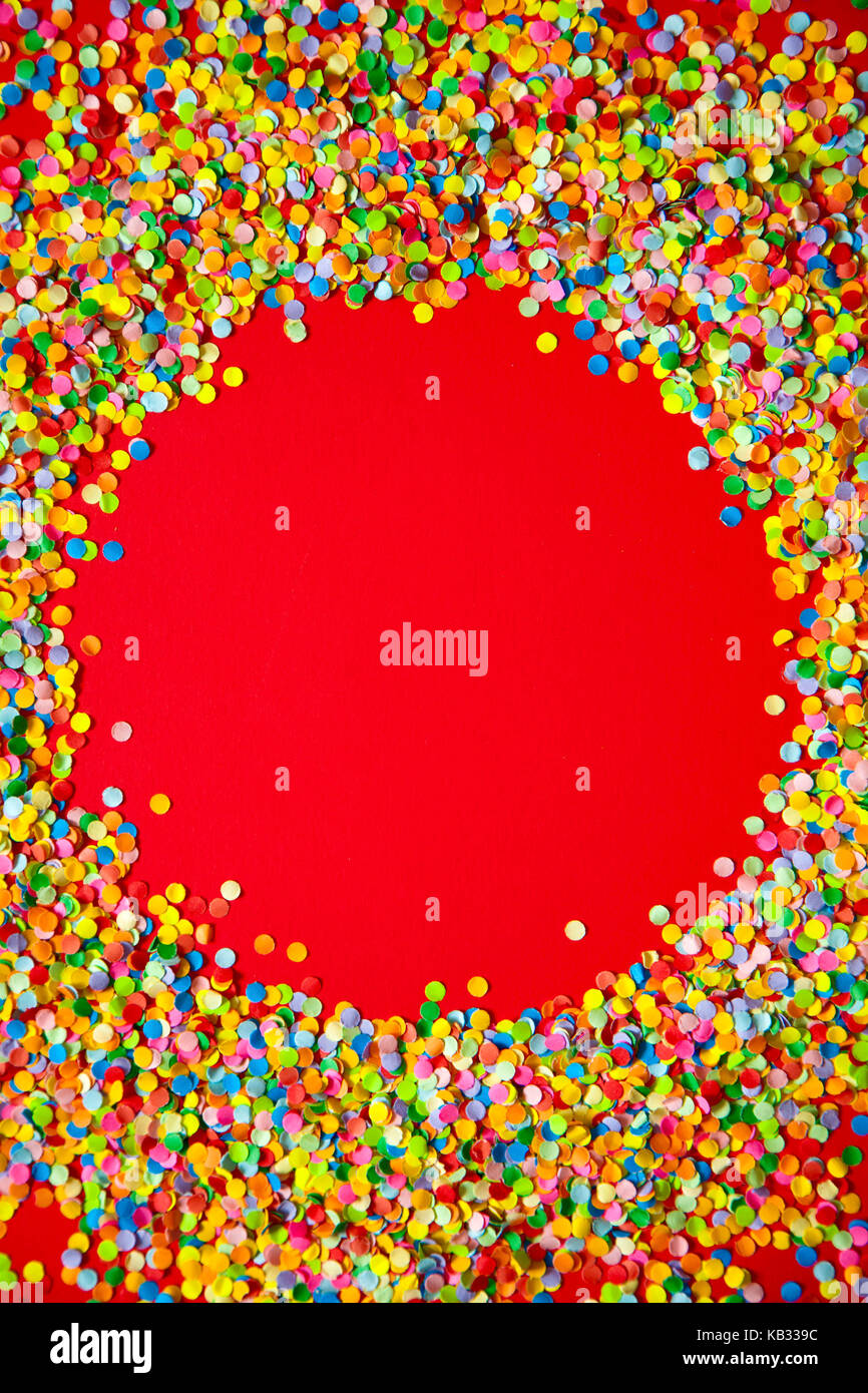 Frame made of colored confetti. Red background Stock Photo - Alamy
