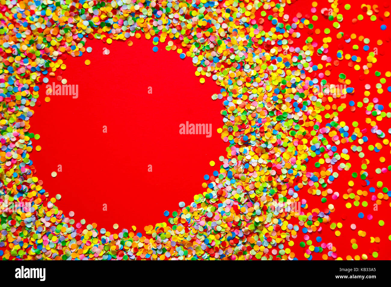 Frame made of colored confetti. Red background Stock Photo - Alamy