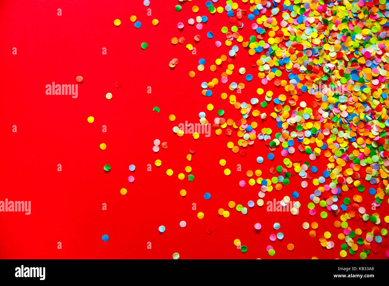 Frame made of colored confetti. Red background Stock Photo - Alamy