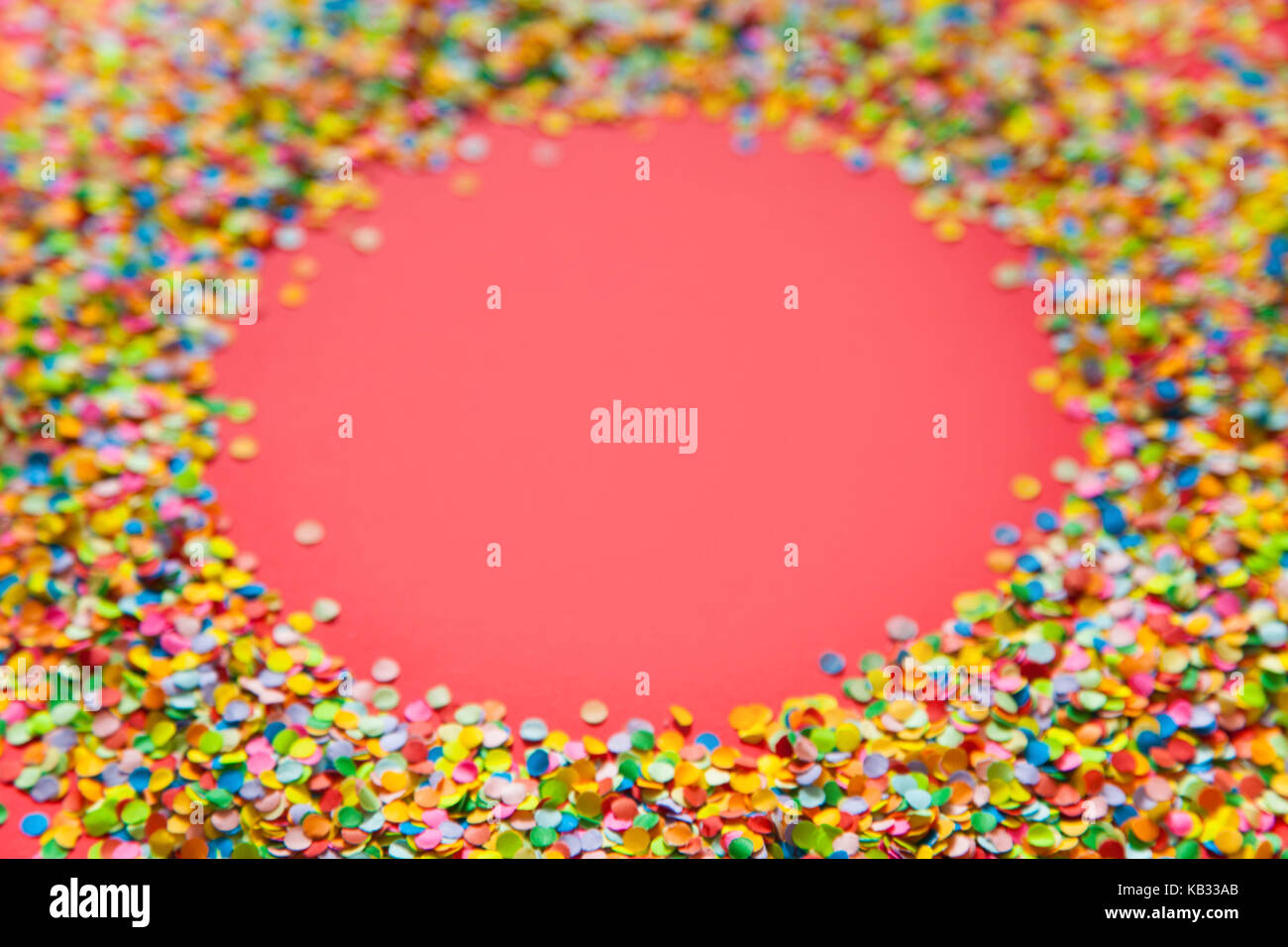 Frame made of colored confetti. Red background Stock Photo - Alamy