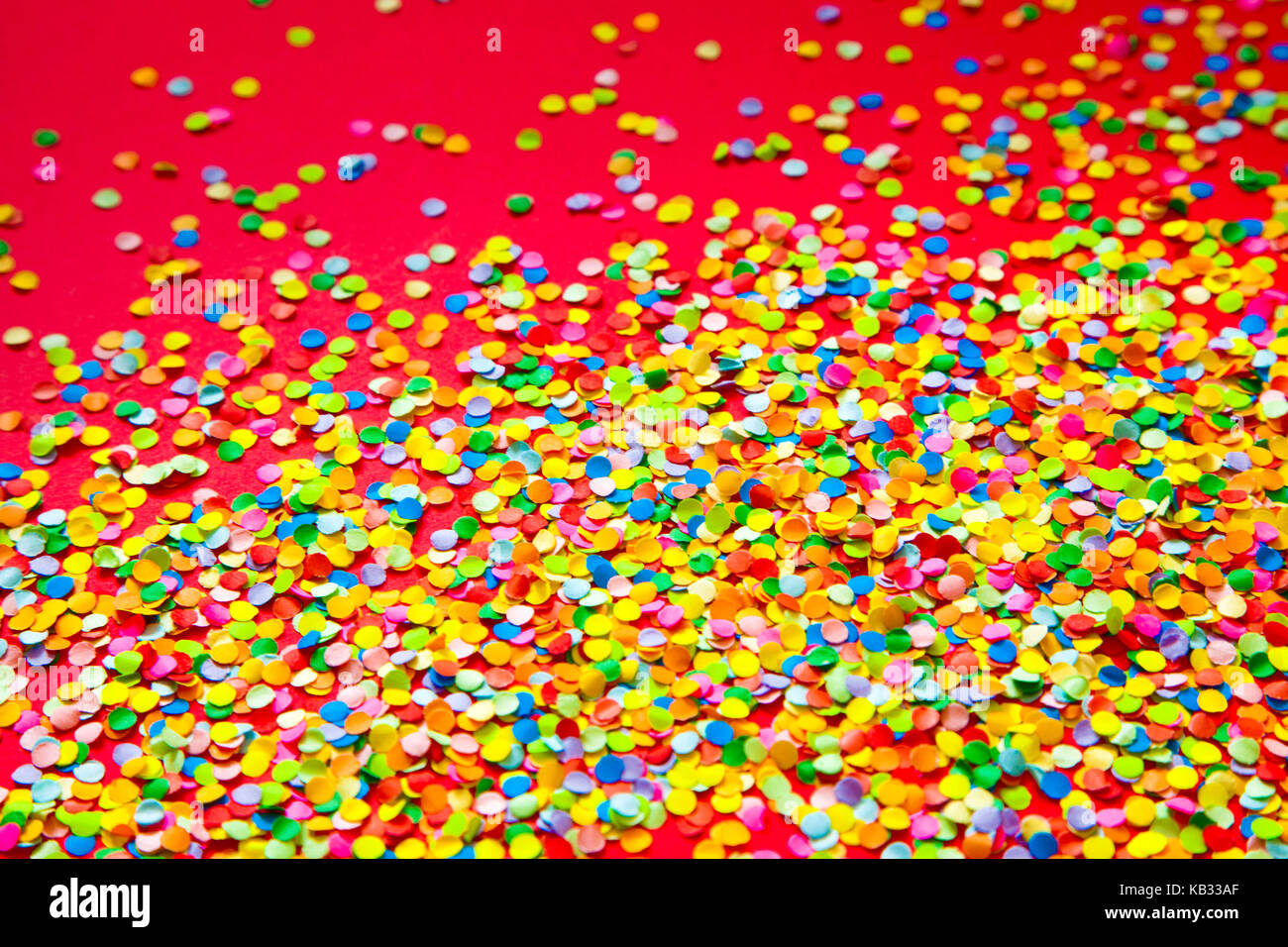Frame made of colored confetti. Red background Stock Photo - Alamy
