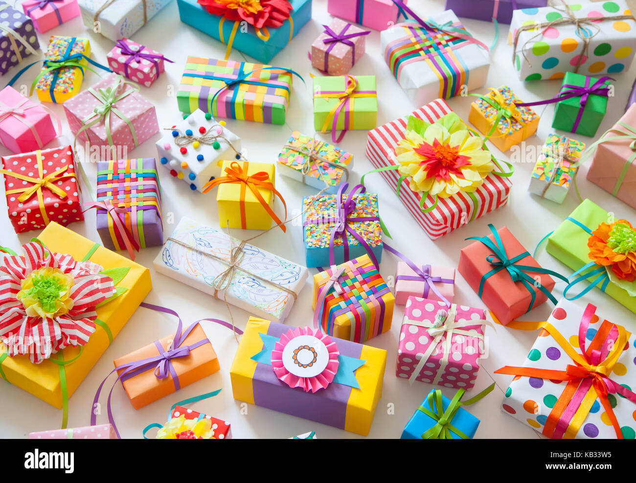 Colored gift boxes with colorful ribbons. White background. Gifts for ...