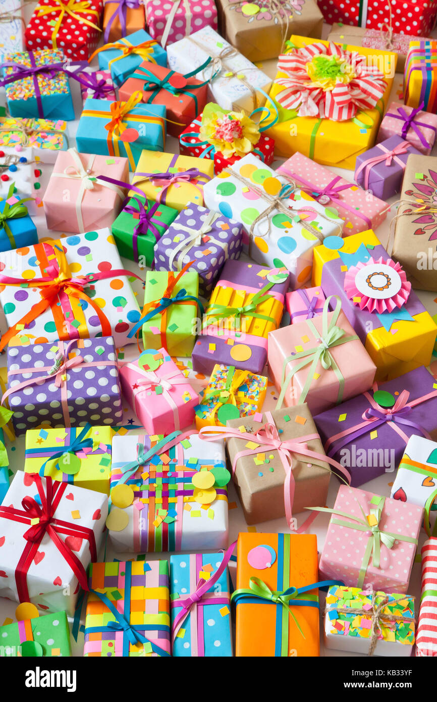Colored gift boxes with colorful ribbons. White background. Gifts for ...