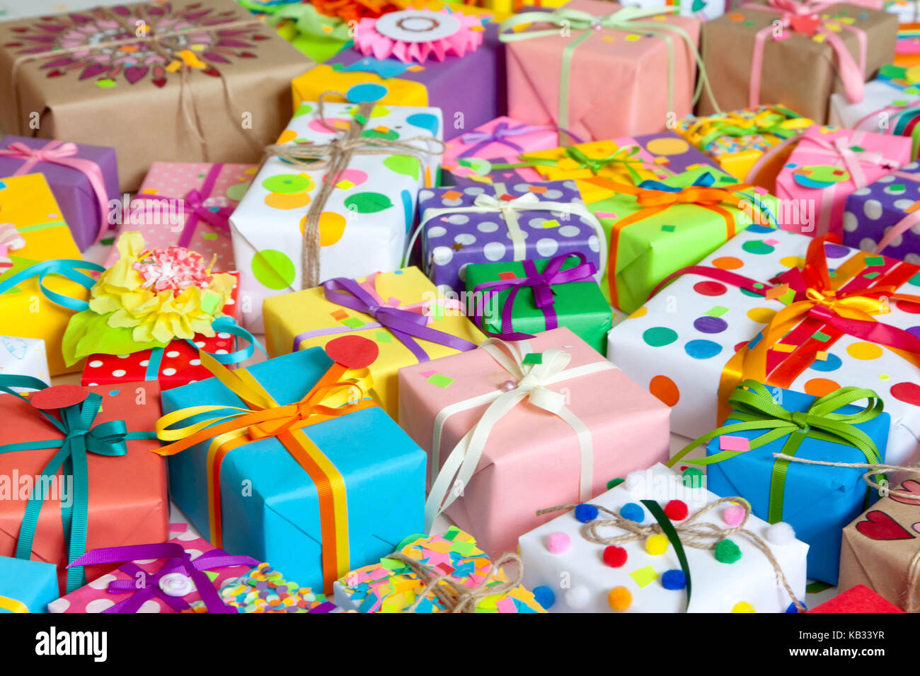 Colored gift boxes with colorful ribbons. White background. Gifts for ...