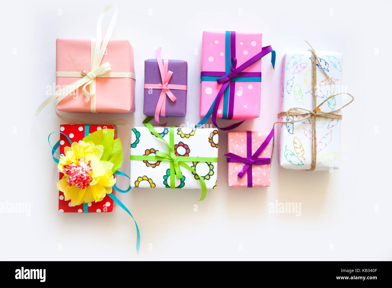 Colored gift boxes with colorful ribbons. White background. Gifts for ...