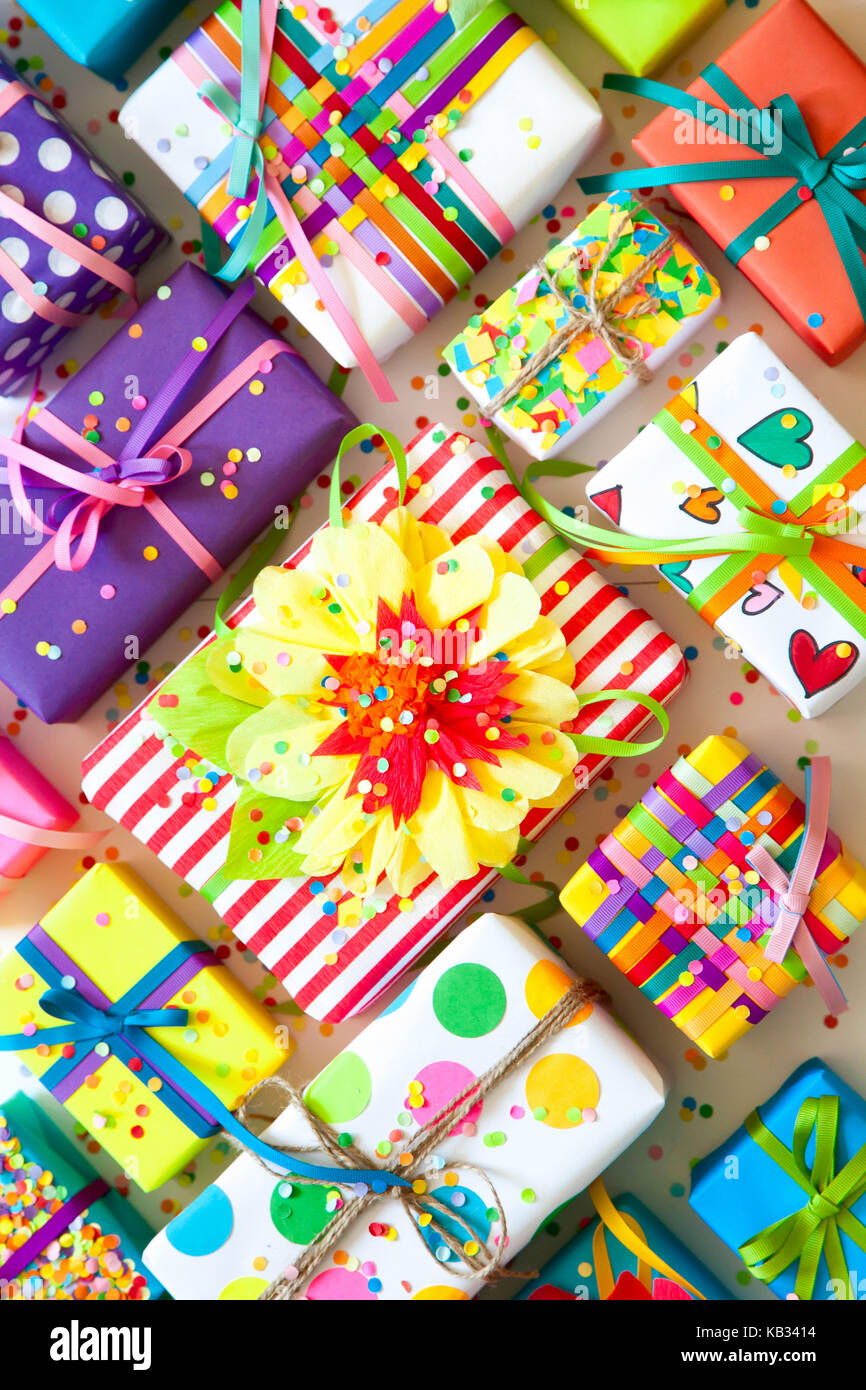 Colored gift boxes with colorful ribbons. White background. Gifts for ...