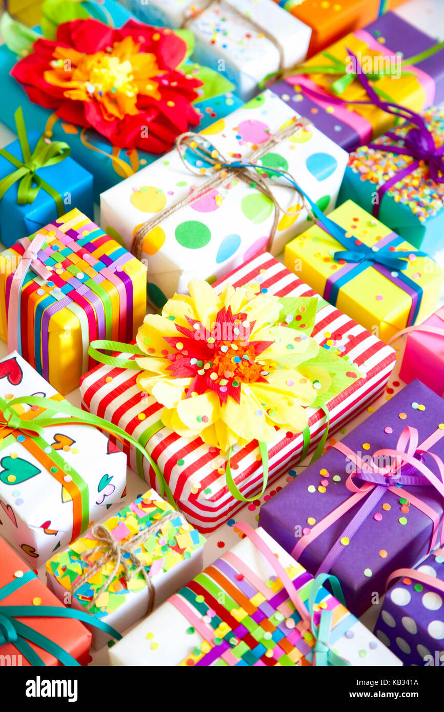 Colored gift boxes with colorful ribbons. White background. Gifts for ...