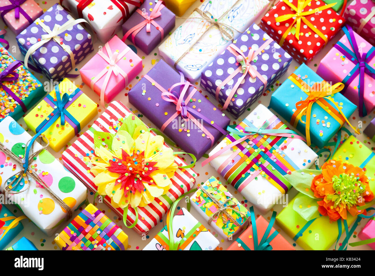 Colored gift boxes with colorful ribbons. White background. Gifts for ...