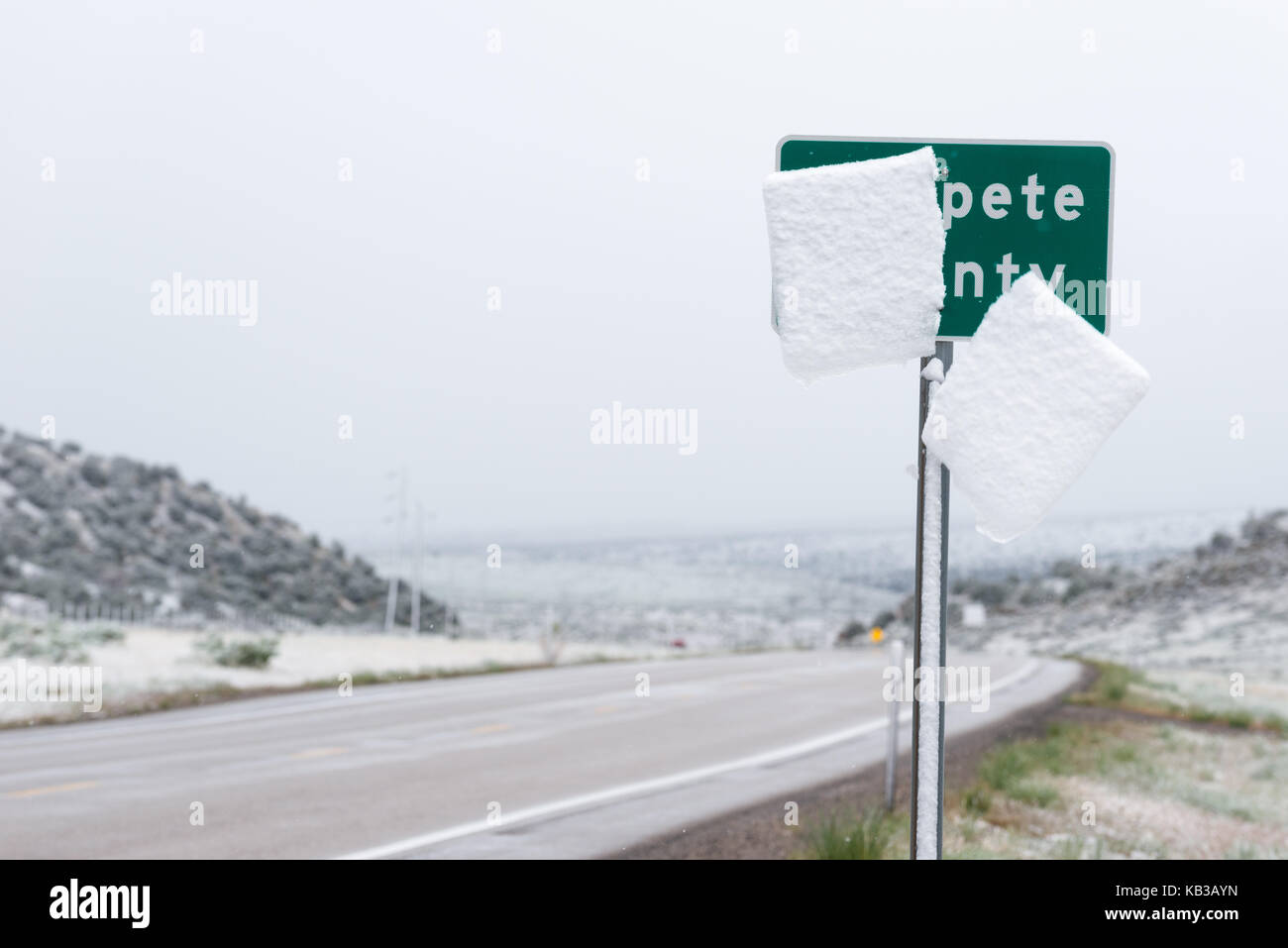 Snow slab sliding off Sanpete County sign along Highway 28 in Central ...
