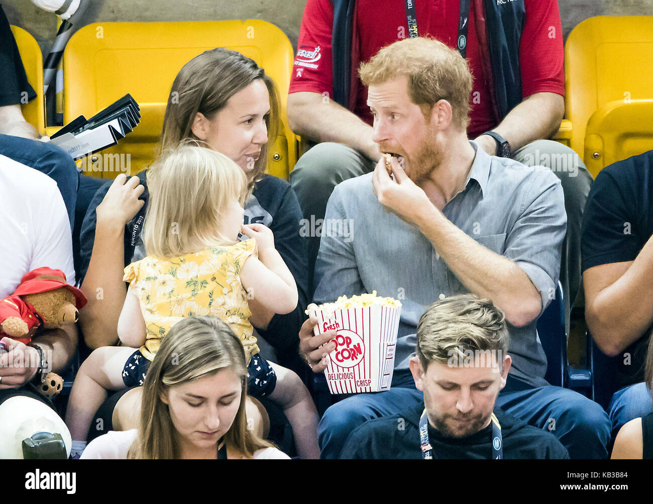 Prince Harry shares his pop corn with Emily Henson, daughter of Hayley ...