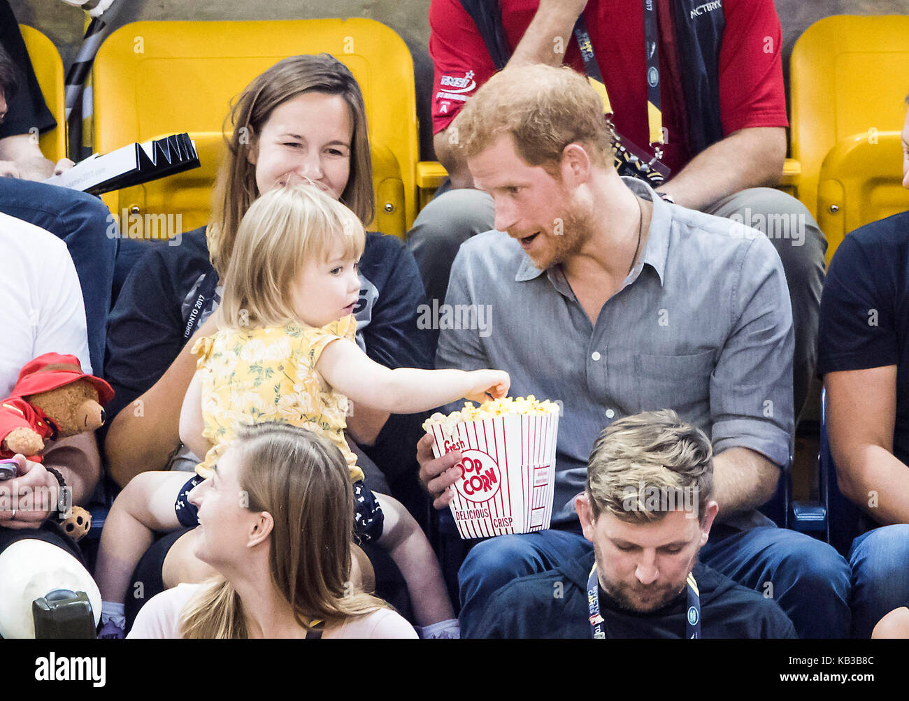 Prince Harry shares his pop corn with Emily Henson, daughter of Hayley ...