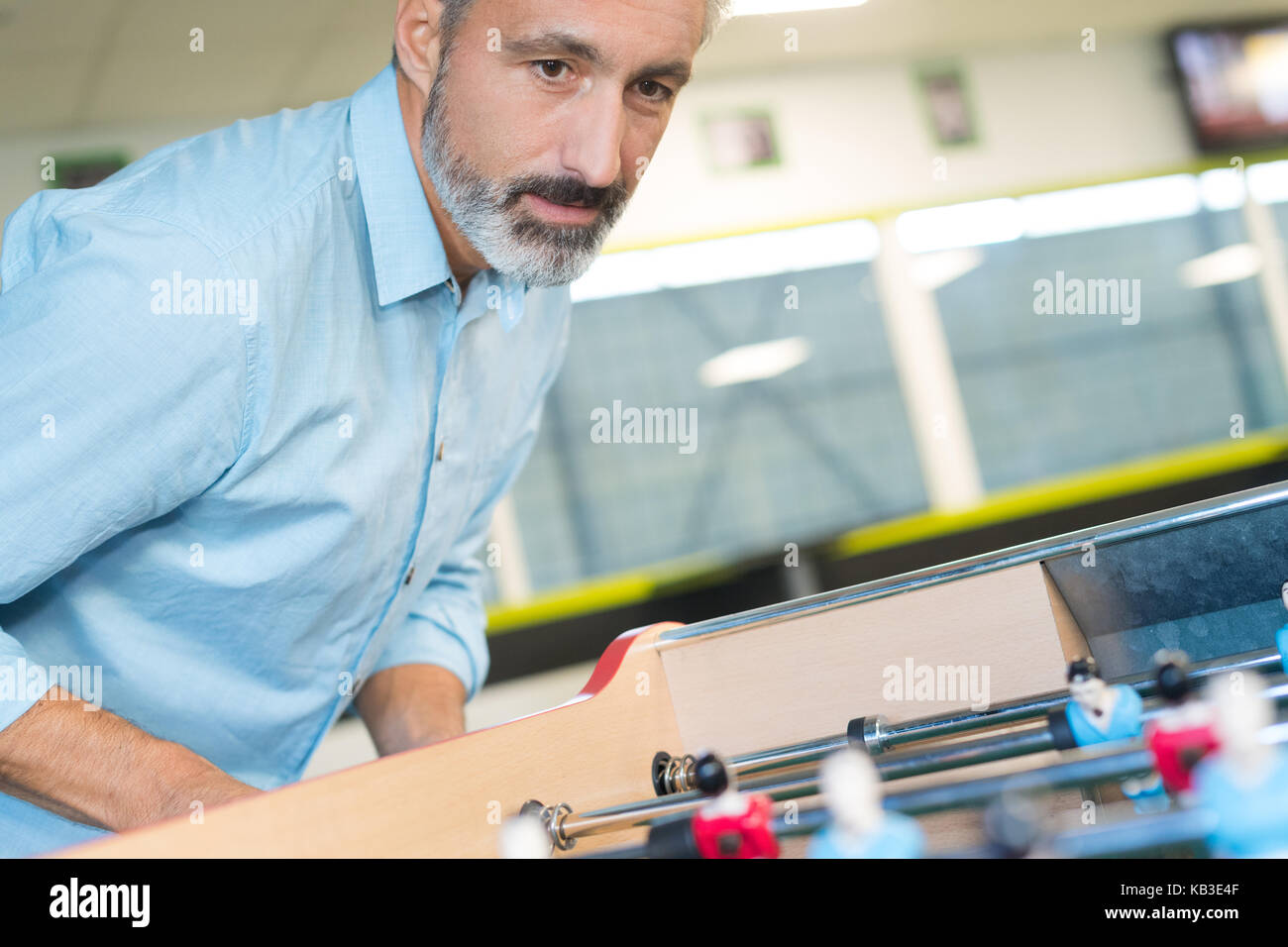 middle-age friends playing soccer table football Stock Photo - Alamy