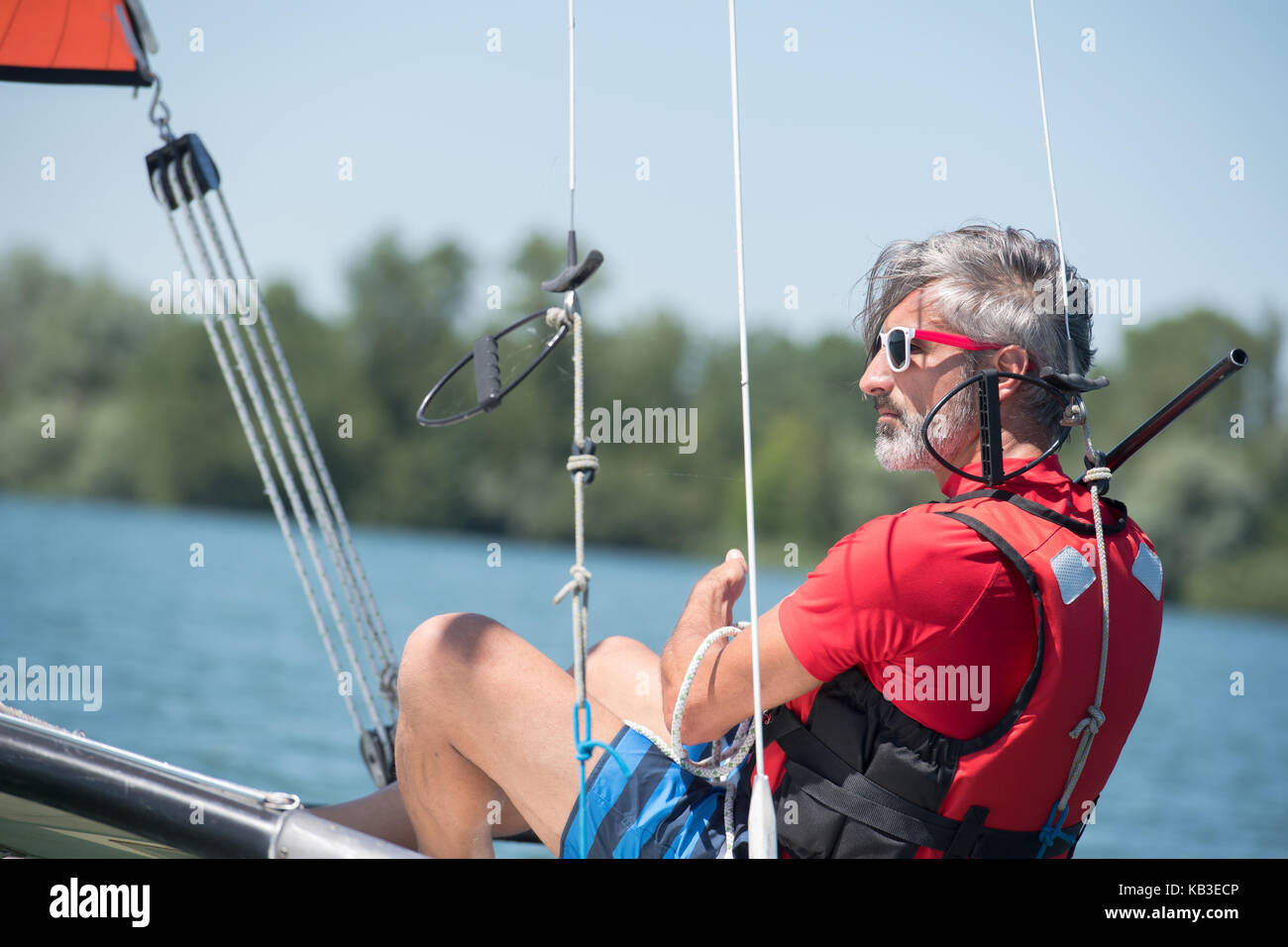 young man skipper at his sail boat Stock Photo - Alamy