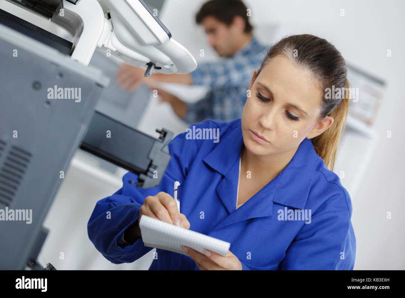 female technician doing maintenance on servers with a clipboard Stock ...