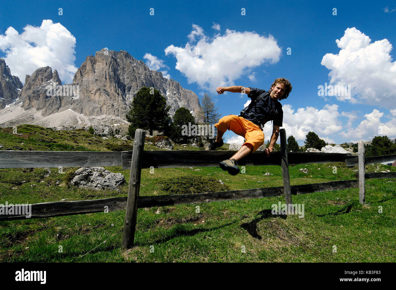 Man jumps over fence Stock Photo - Alamy