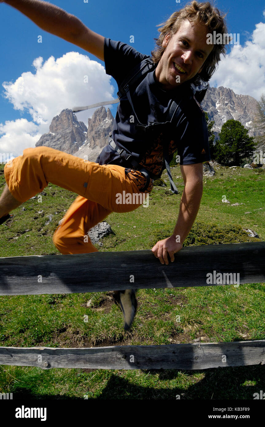 Man jumps over fence Stock Photo - Alamy