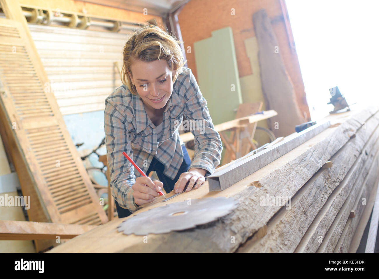 female carpenter draws sketches in pencil in a notebook Stock Photo - Alamy