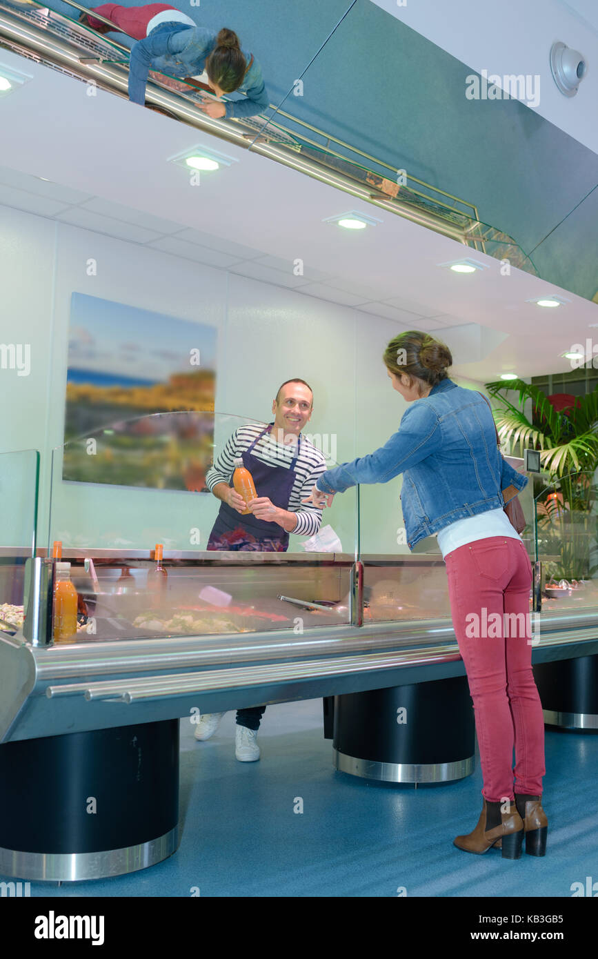 young female customer buying fish in shop Stock Photo - Alamy
