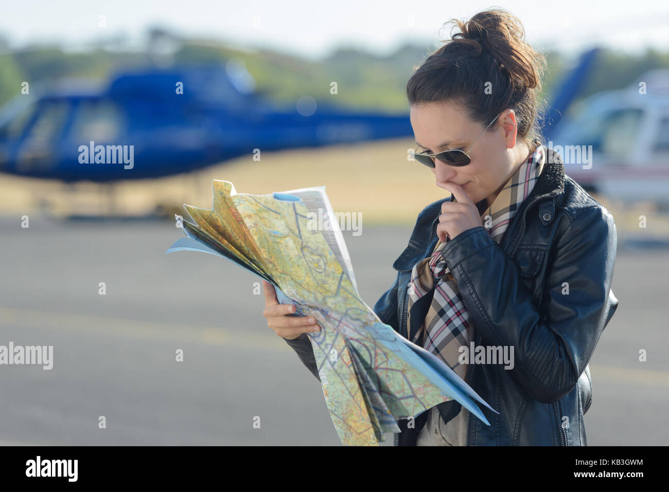 woman helicopter in background pilot reading map Stock Photo - Alamy