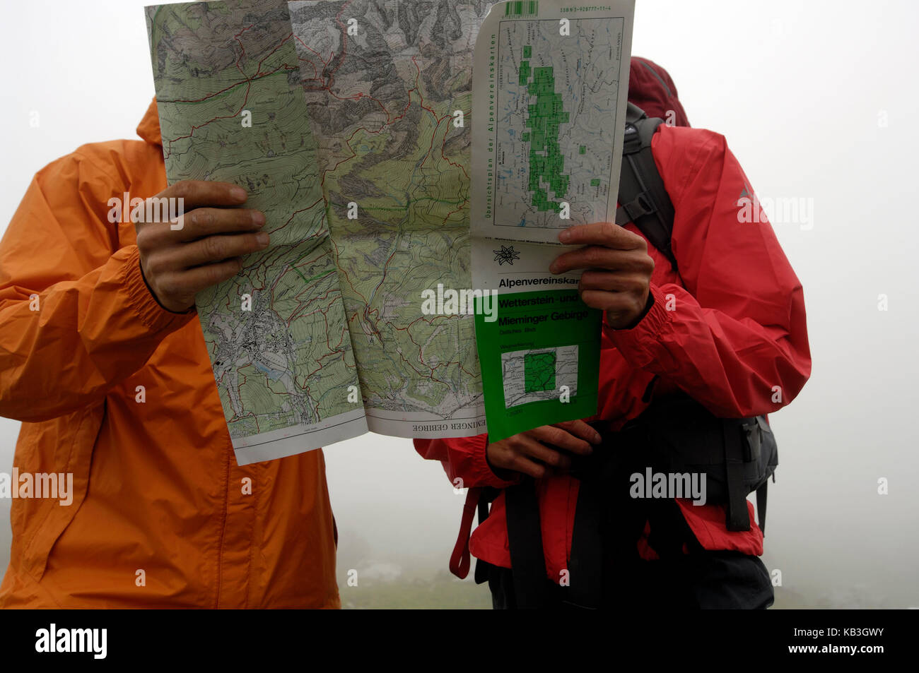 Mountain hiker while reading the hiking map hi-res stock photography ...