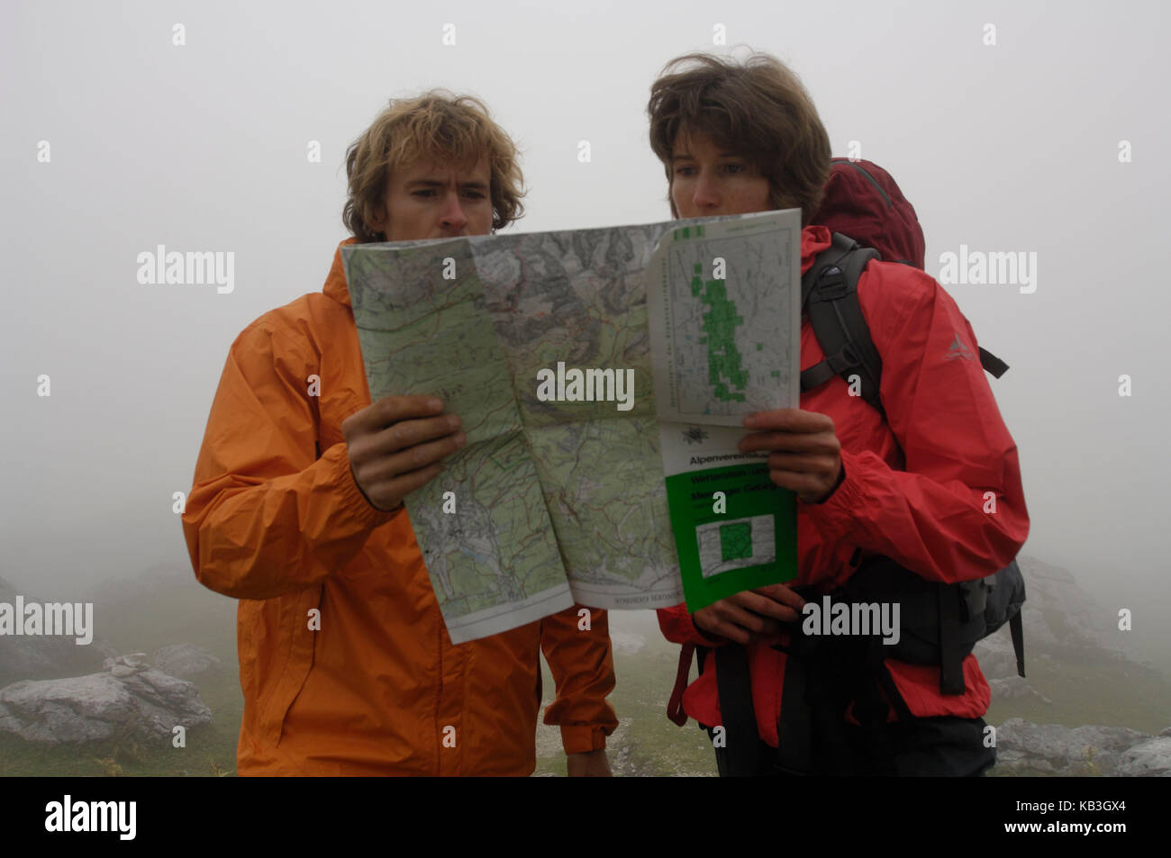 Mountain Hiker while reading the hiking map Stock Photo - Alamy