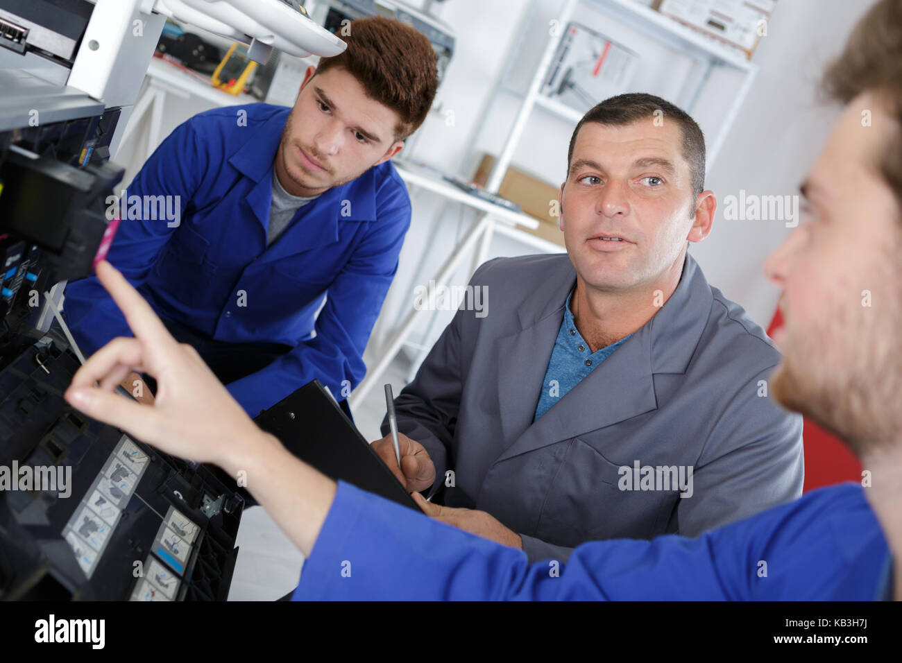training male apprentices to use mechanized saw Stock Photo - Alamy