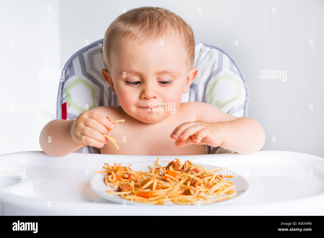 Little baby eating her dinner and making a mess Stock Photo - Alamy