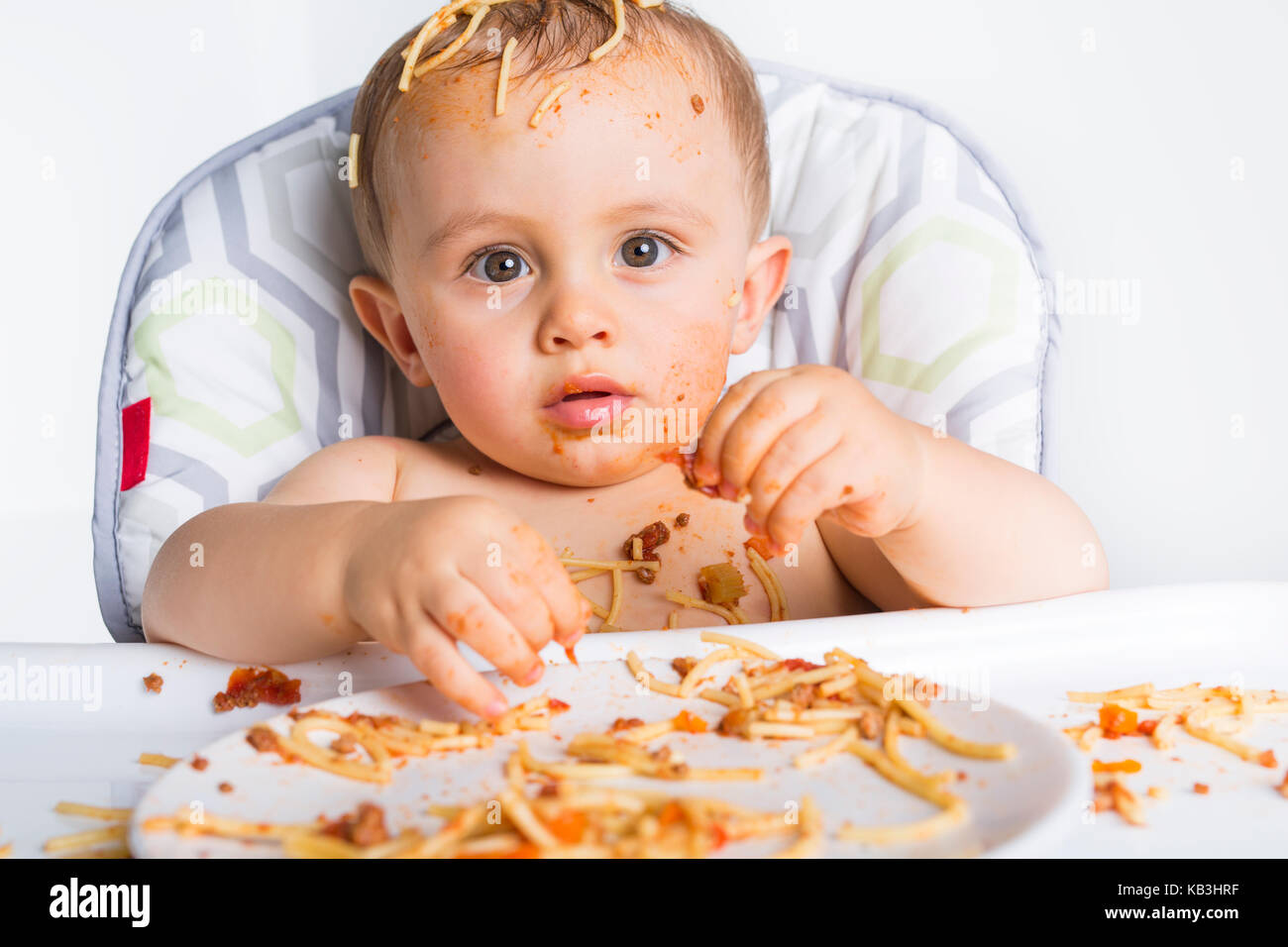 Little baby eating her dinner and making a mess Stock Photo - Alamy