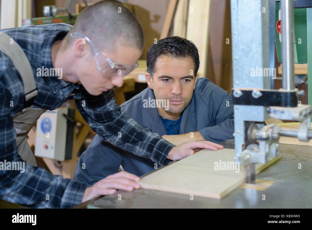 carpenter teaching apprentice how to measure wood Stock Photo - Alamy