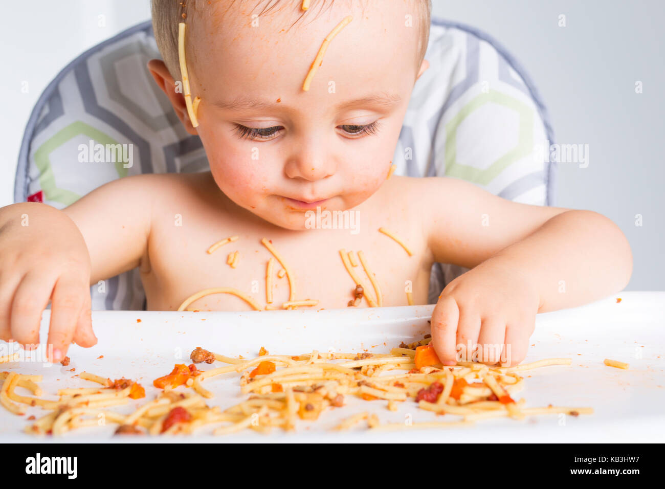 Little baby eating her dinner and making a mess Stock Photo - Alamy