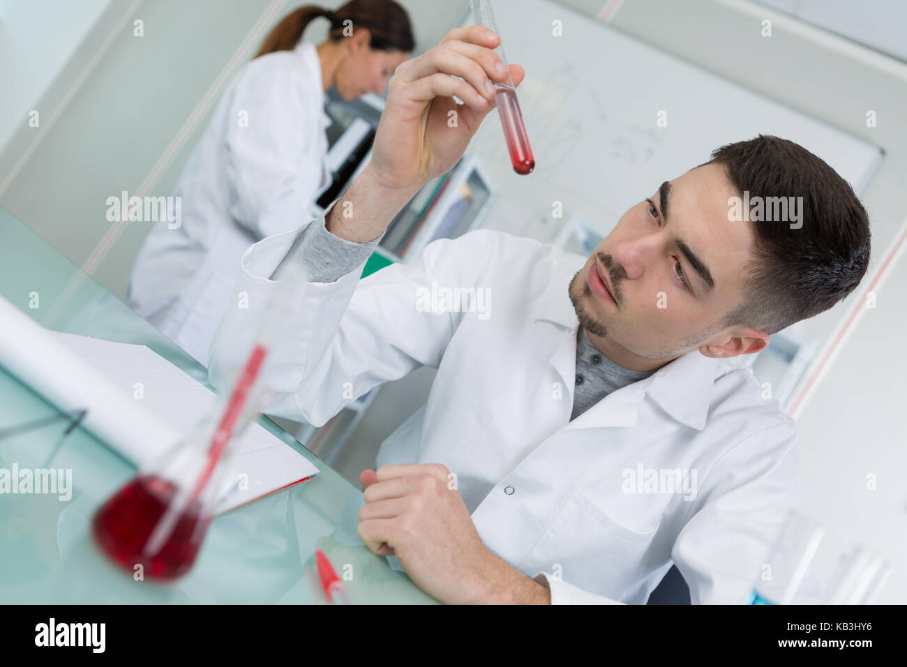 male scientist holding test tube with blood sample Stock Photo - Alamy