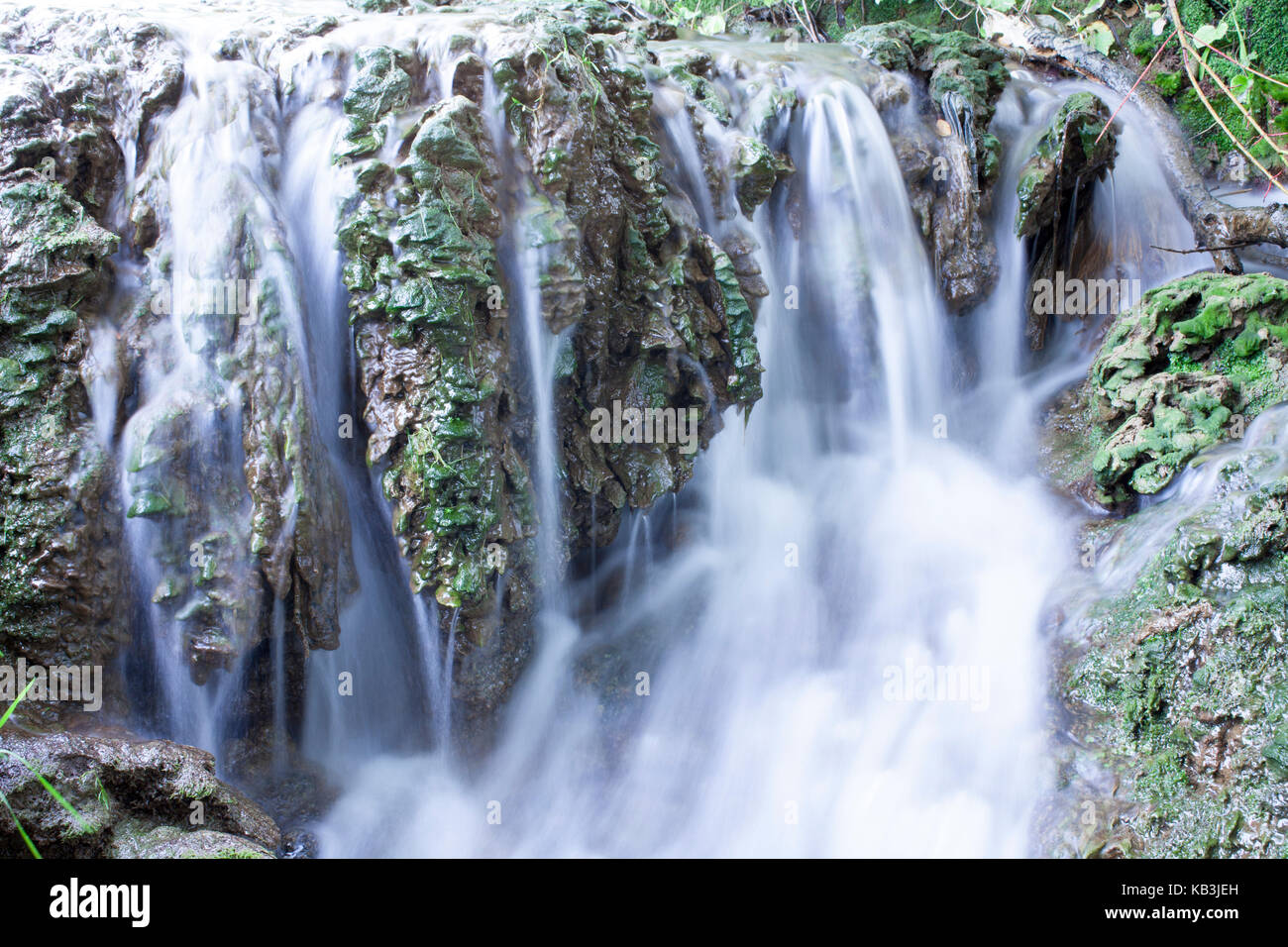 Stream blurred water in small waterfall Stock Photo - Alamy