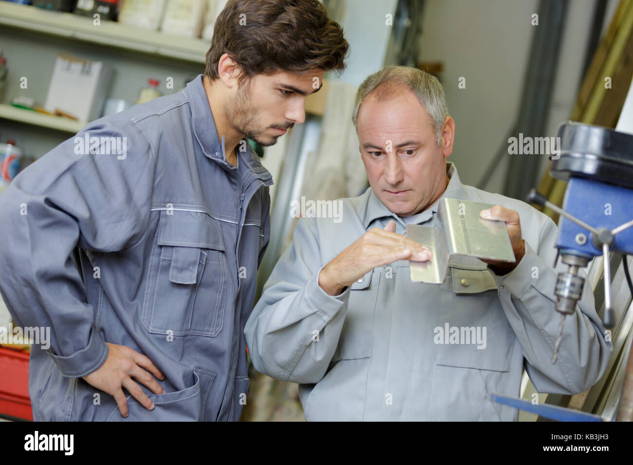 teacher with student in mechanics class Stock Photo - Alamy