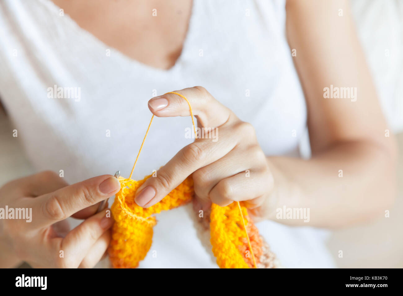 A woman knits a colored cloth. Hands close-up Stock Photo - Alamy