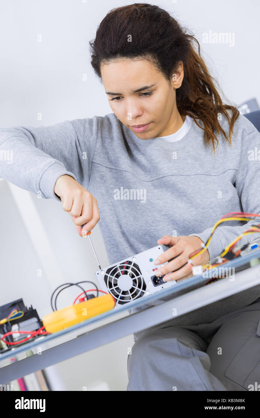 young computer engineer fixing broken pc parts Stock Photo - Alamy