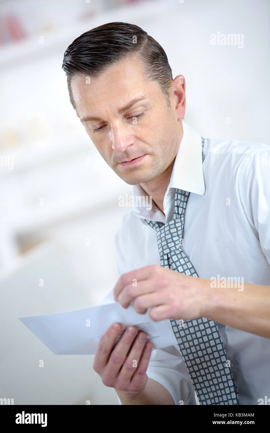 businessman opening a letter Stock Photo - Alamy