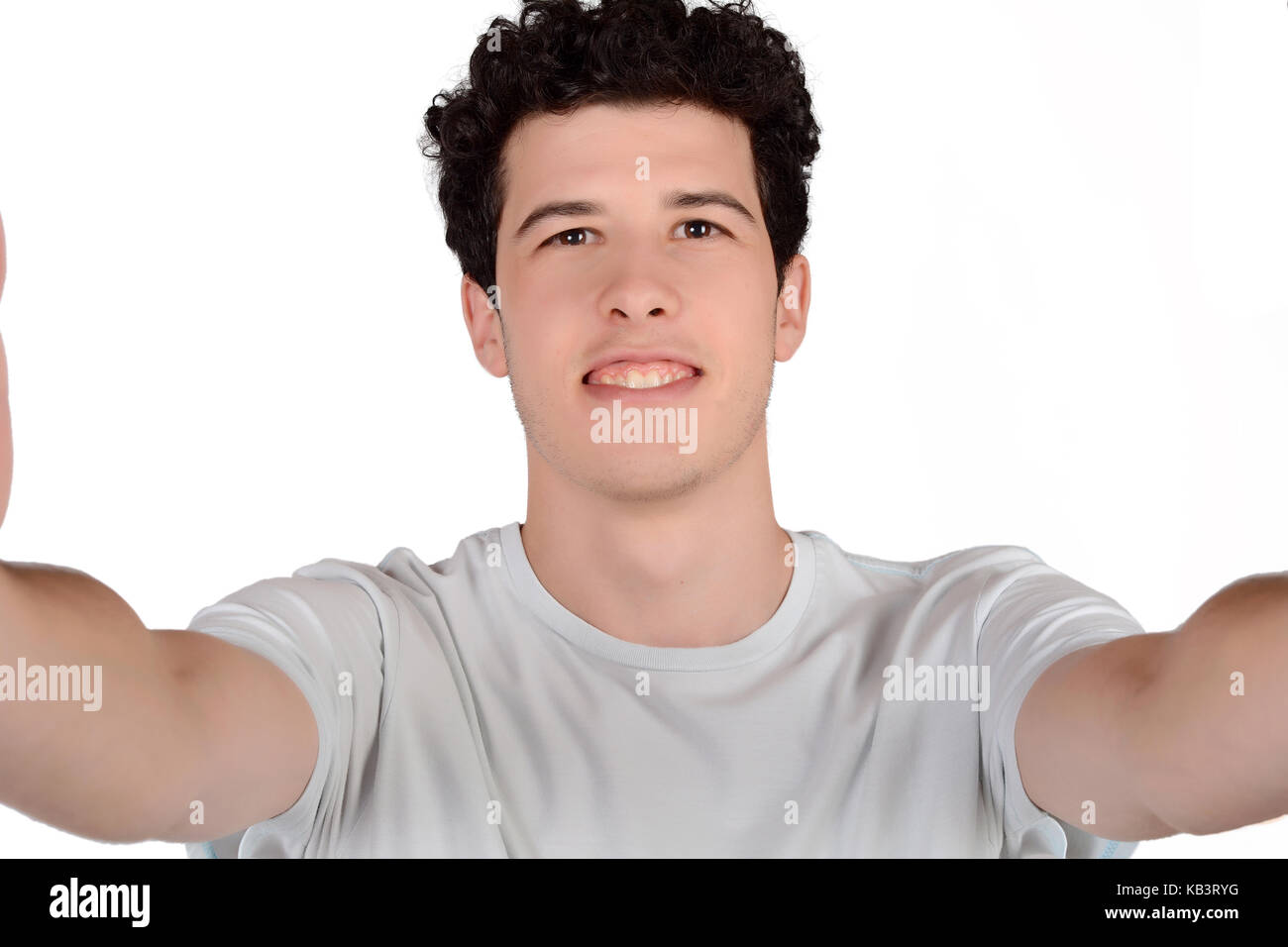 Portrait of a young handsome man taking a selfie. Isolated white ...
