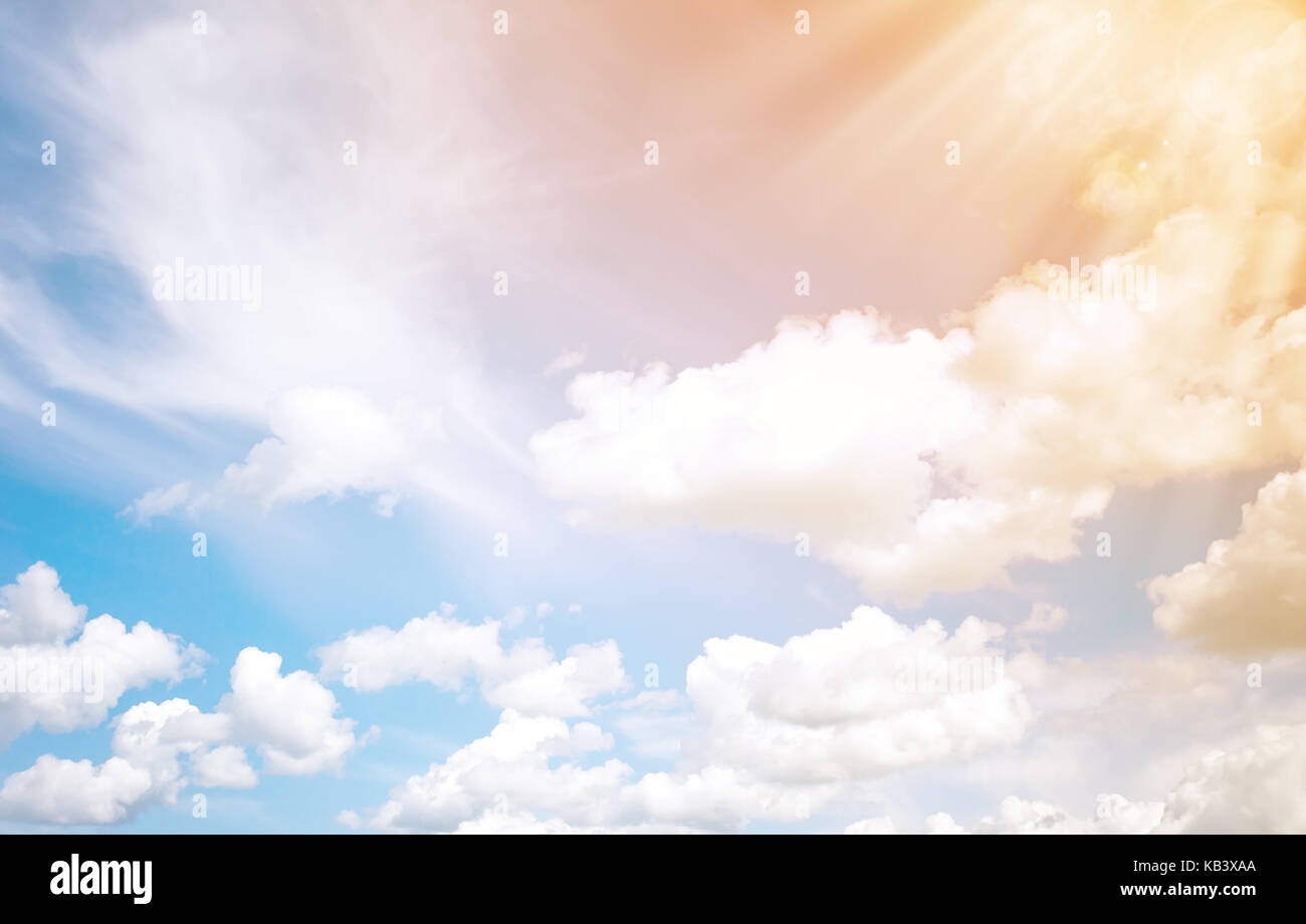 White fluffy clouds and sun background Stock Photo - Alamy