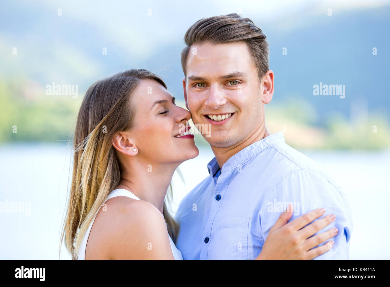 Picture of beautiful young couple cuddling and posing outdoor Stock ...