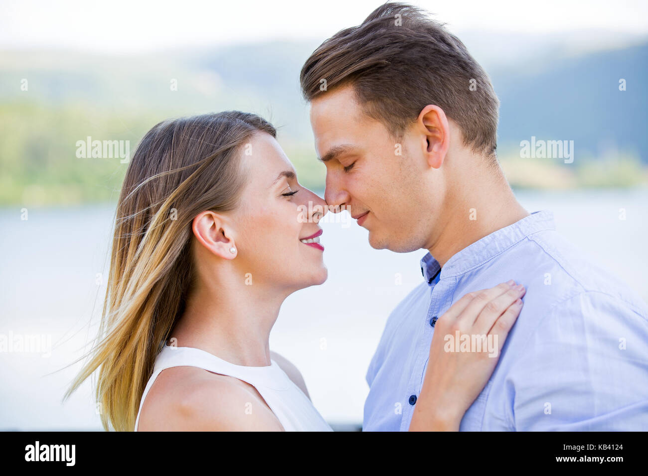 Picture of beautiful young couple cuddling and posing outdoor Stock ...