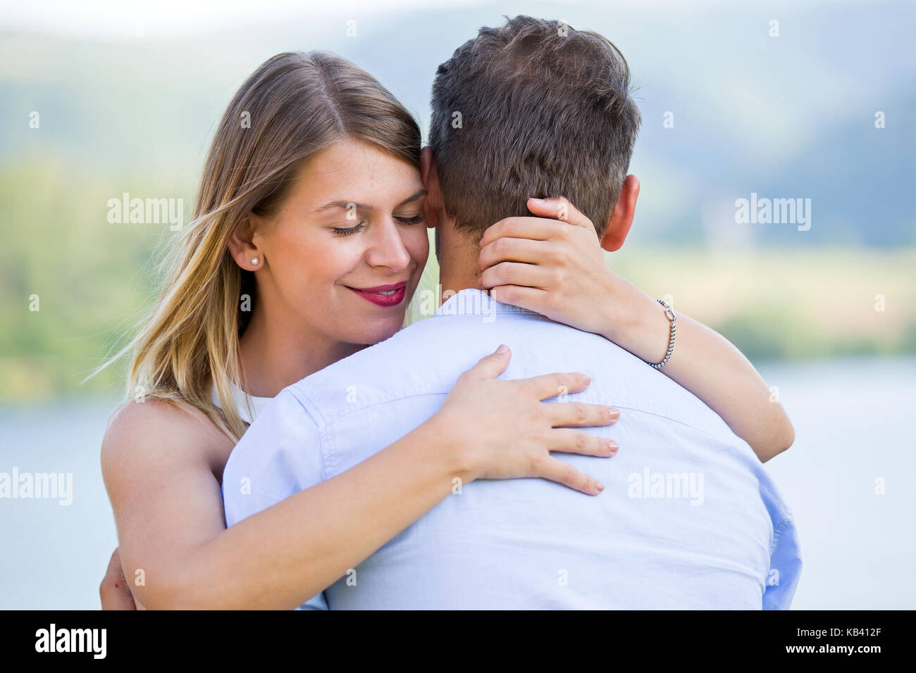 Picture of beautiful couple in love cuddling and posing outdoor Stock ...