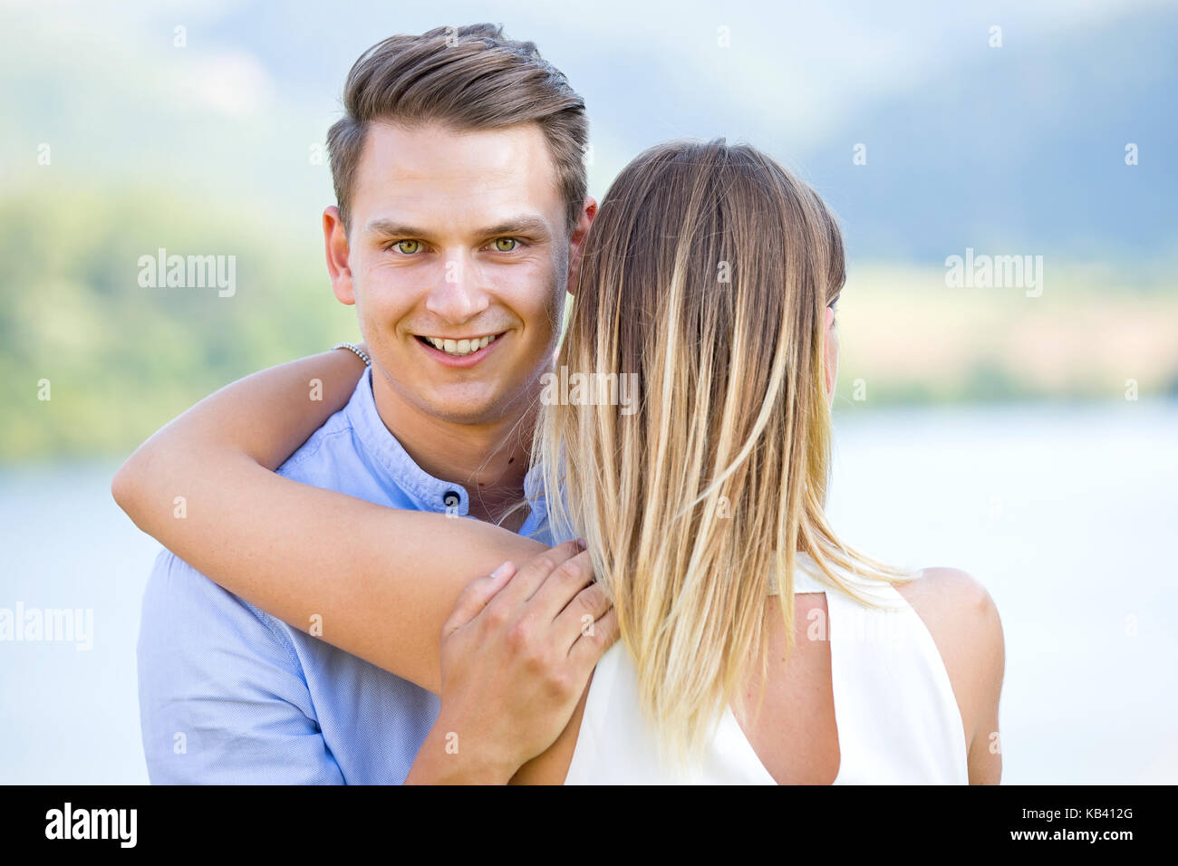 Picture of beautiful couple in love cuddling and posing outdoor Stock ...