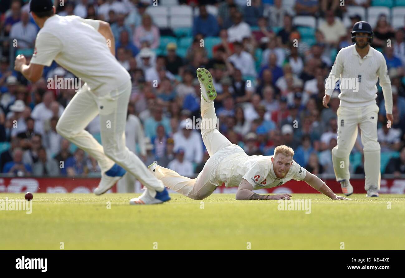 Ben Stokes of England dives to field the ball off his own bowling ...