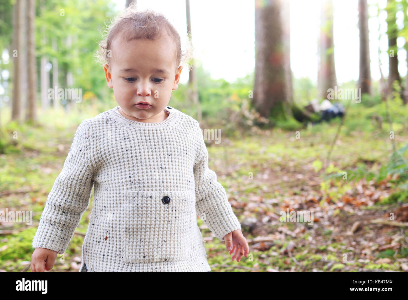 Happy child playing in a forest Stock Photo - Alamy