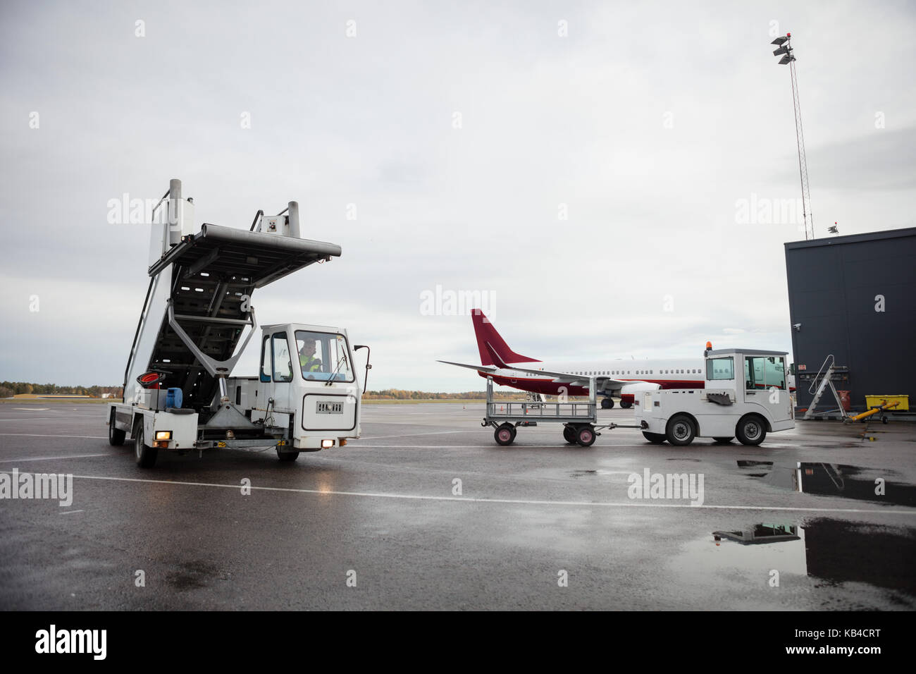 Mobile gangway on runway at airport against cloudy sky Stock Photo - Alamy