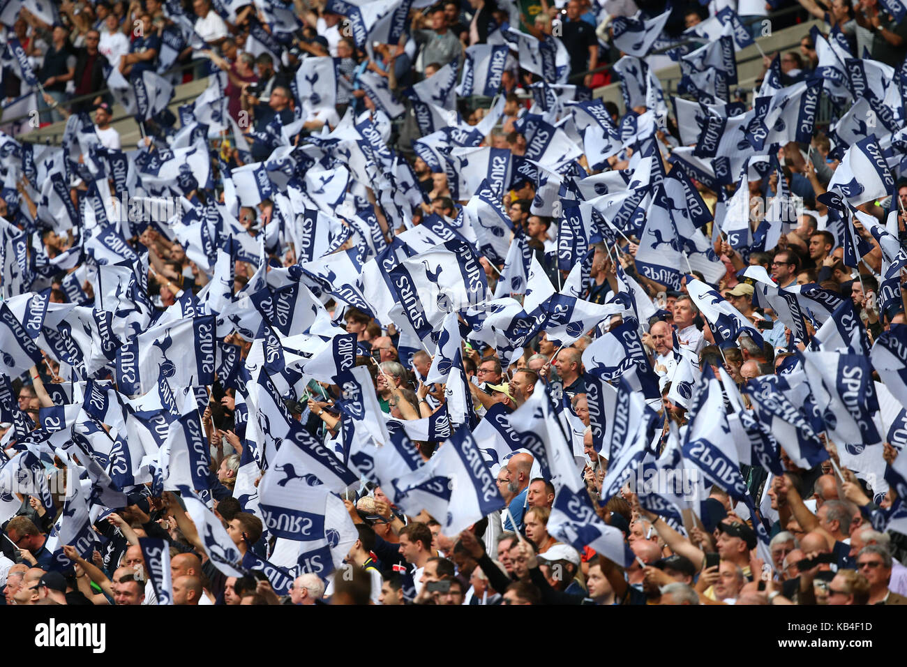Tottenham fans wave flags during the Premier League match between ...