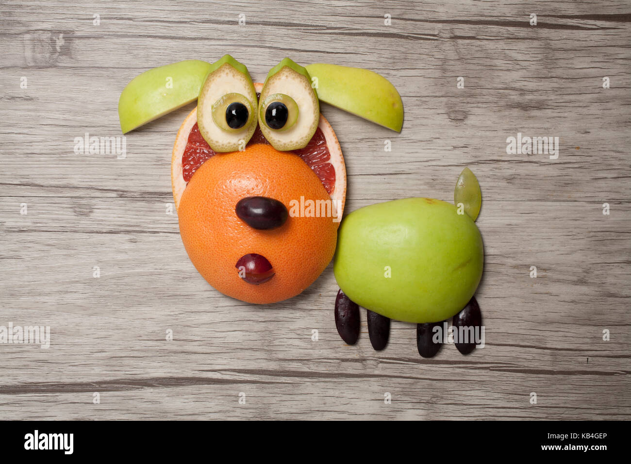 Dog made with fruits on wooden background Stock Photo - Alamy